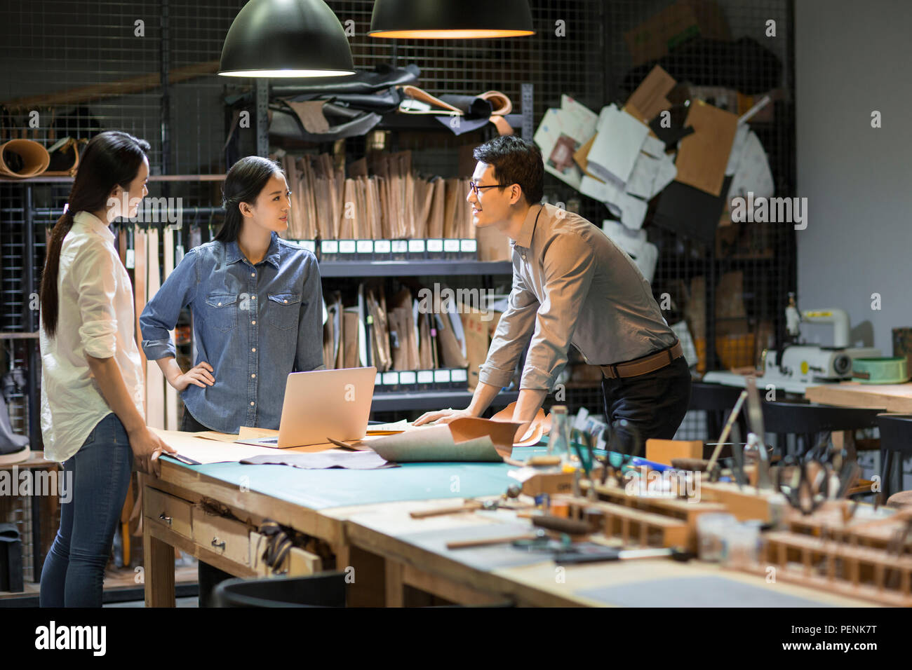 Confident leather craftspeople working in studio Stock Photo - Alamy
