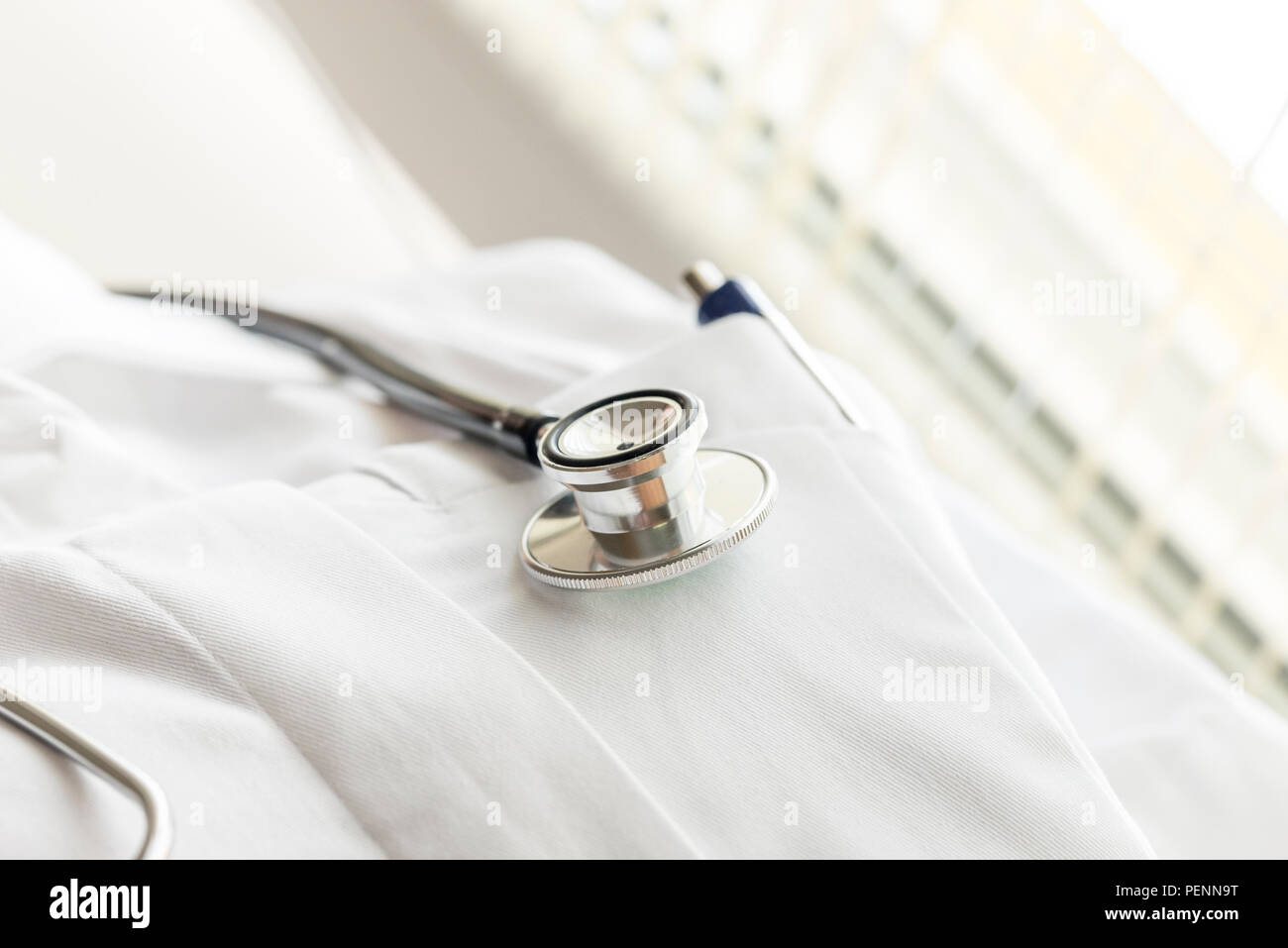Stethoscope lying on a white lab coat in a hospital ready for a nurse ...