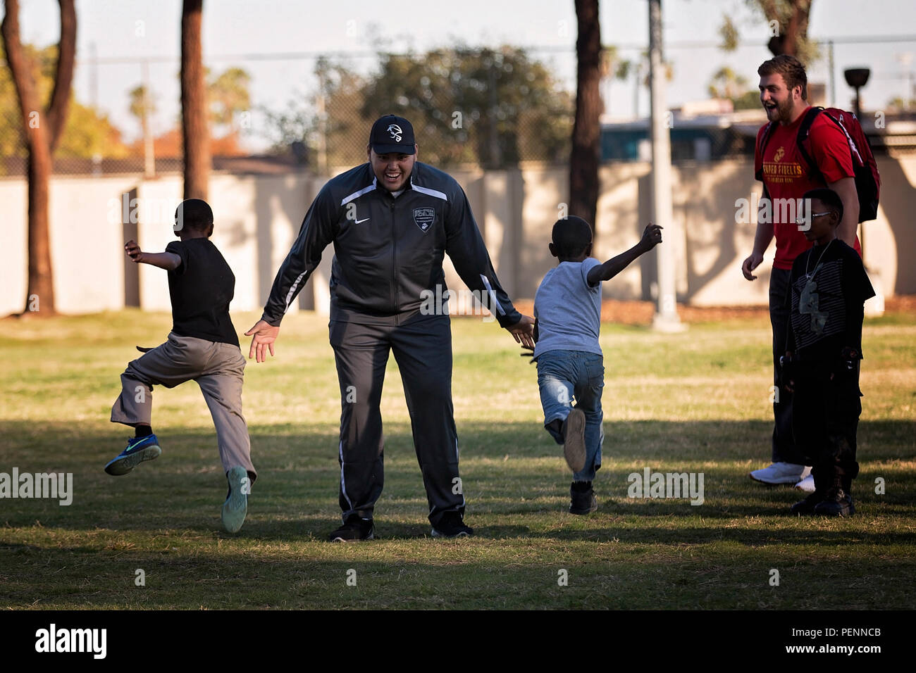 Two children from the Carson, Calif., community race toward Sean Auwae ...