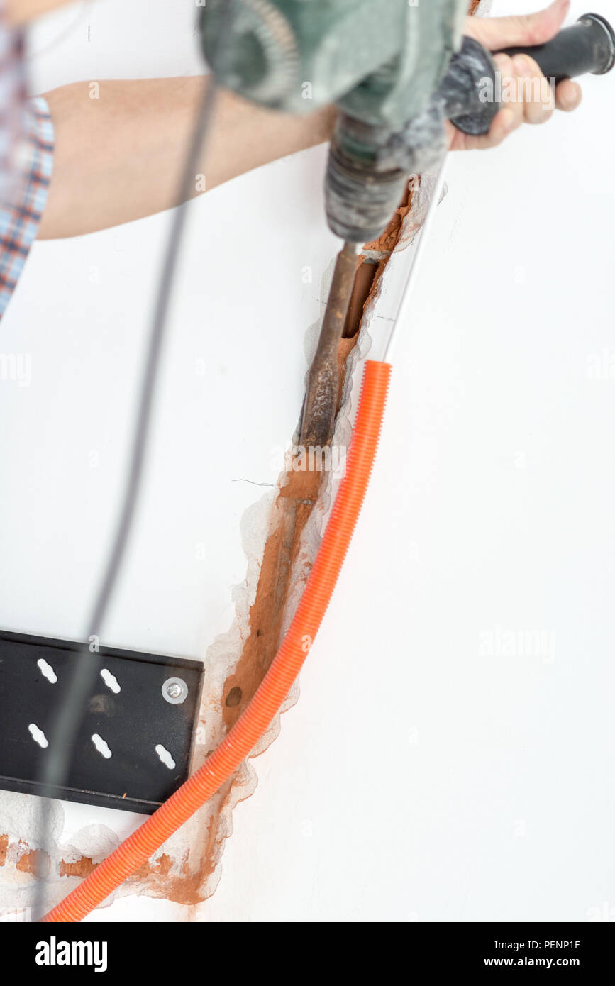 Close up Repairman Installing Orange Corrugated Cable Duct Inside the ...