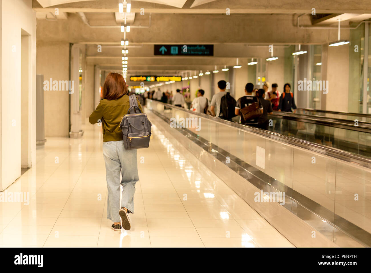 Asian woman with backpack walking to the gate in airport terminal Stock ...