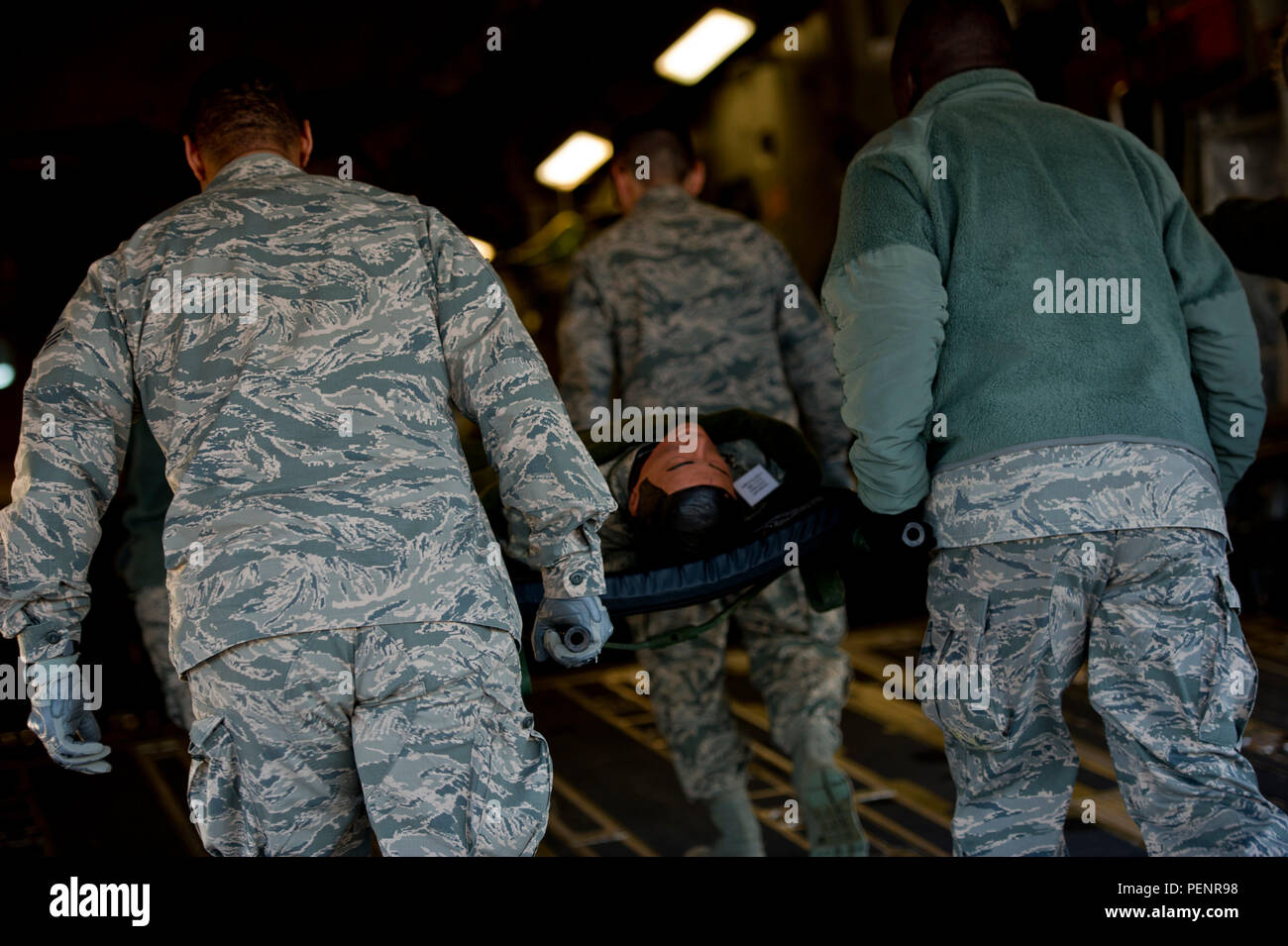Members of the 446th Aeromedical Staging Squadron work to load patients ...