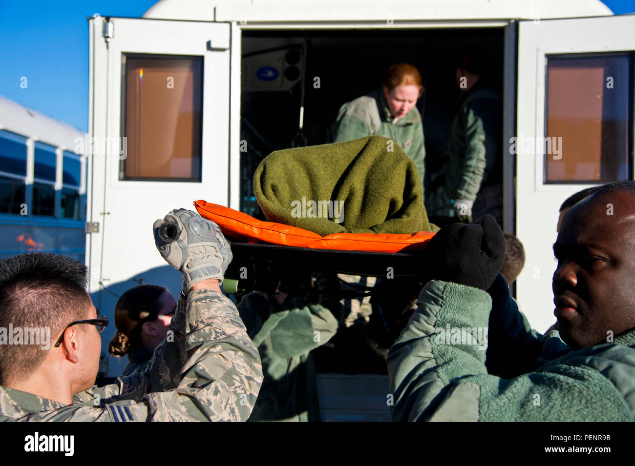 Members of the 446th Aeromedical Staging Squadron work to load patients ...
