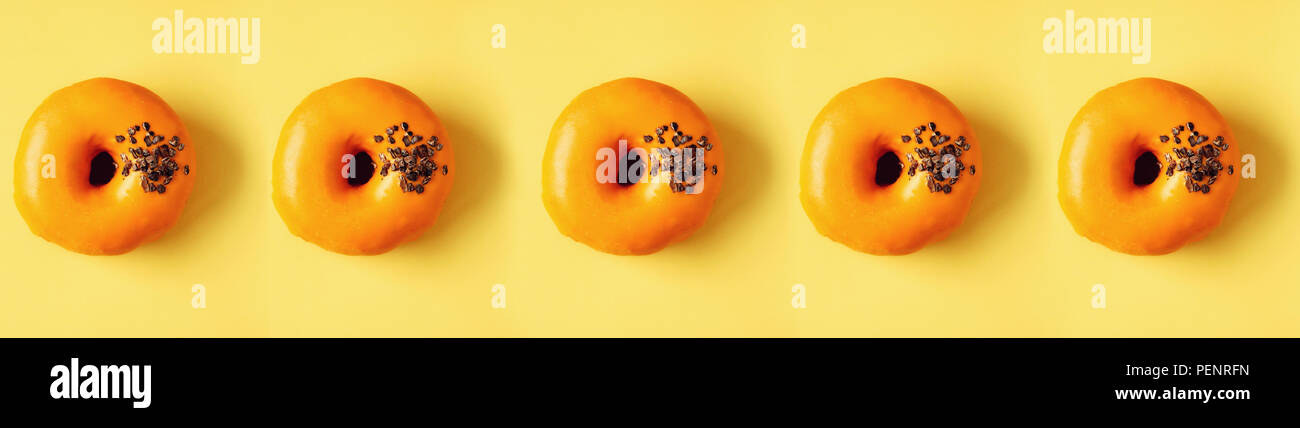 Flat lay donuts pattern on pastel orange background. Top view. Square ...