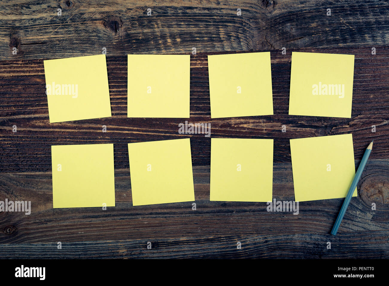 Bunch of yellow sticky notes on the wooden background Stock Photo - Alamy