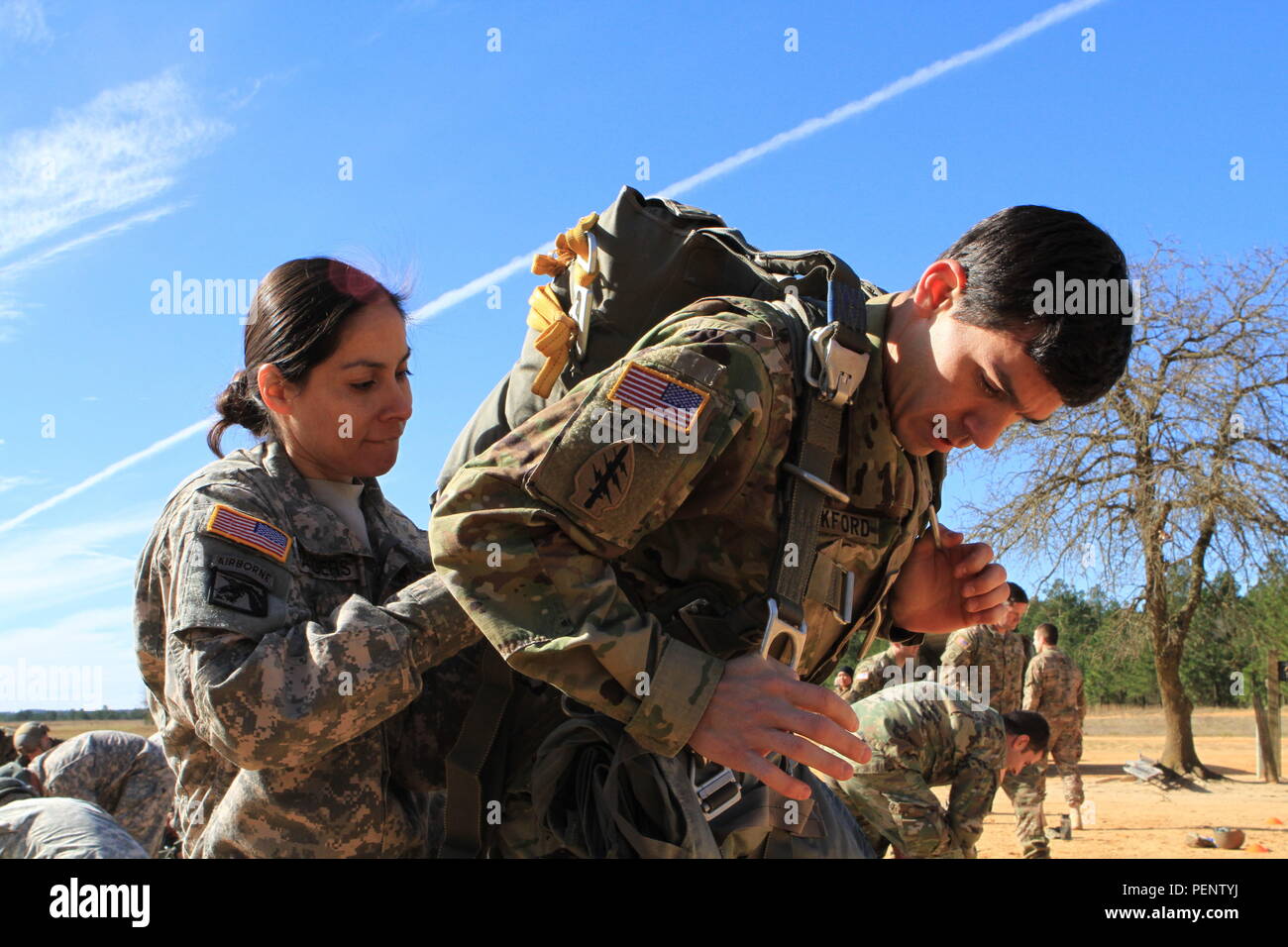 U.S. Army Master Sgt. Arcelia Staggers a rigs a fellow jumper during ...