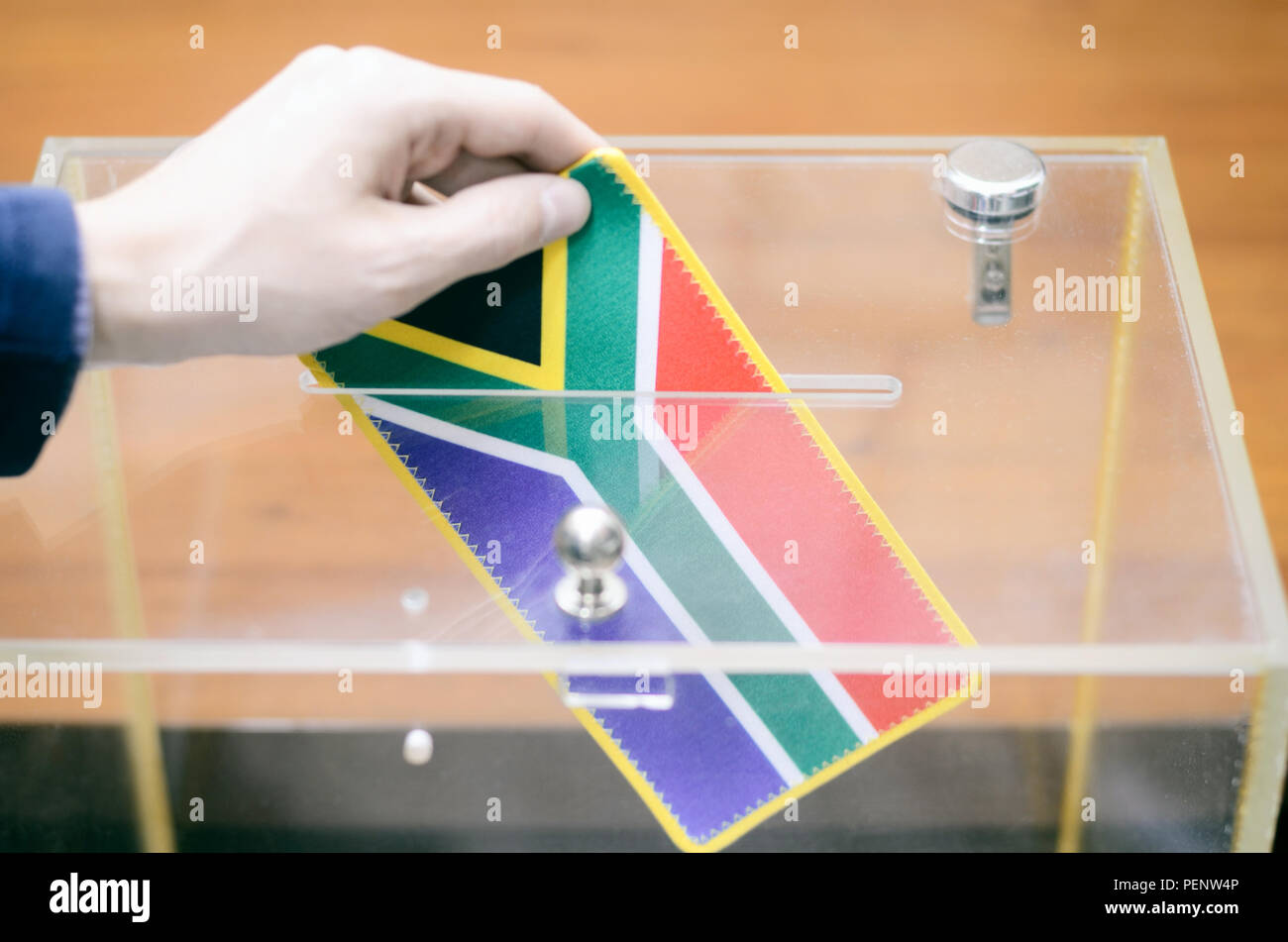Man inserting Flag of South Africa into ballot box, voting and ...