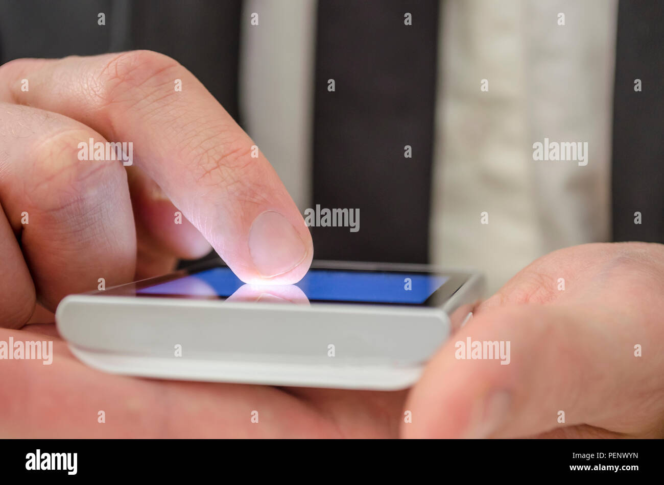 Finger of a businessman pointing at touch screen of smart phone Stock ...