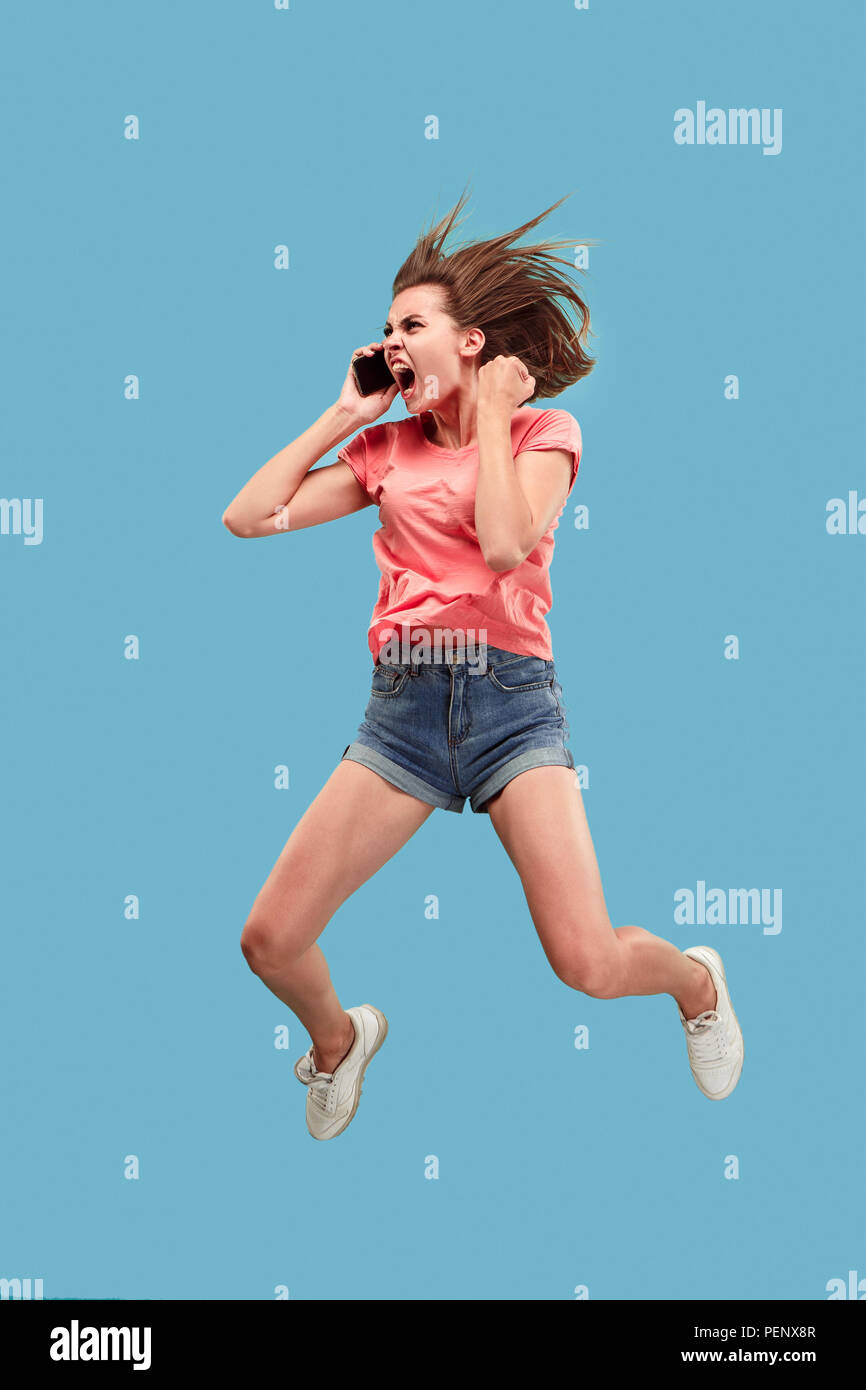 always on mobile. Full length of pretty young woman taking phone while ...