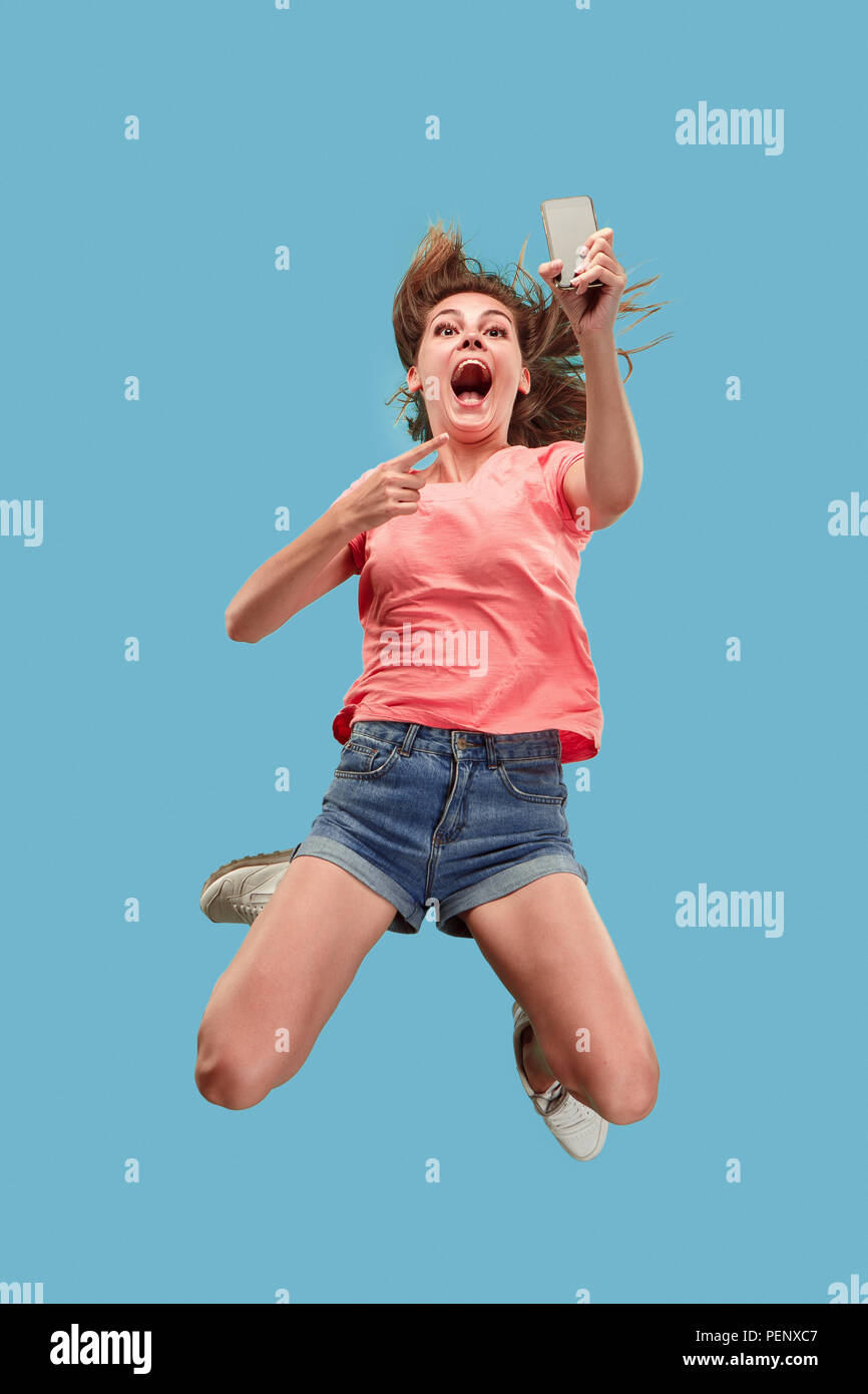 always on mobile. Full length of pretty young woman taking phone while ...