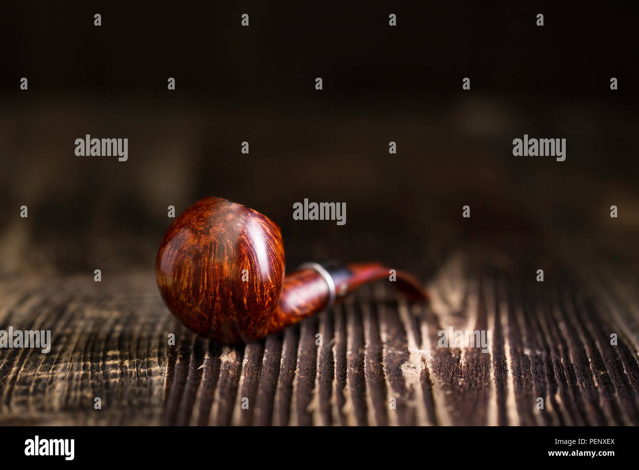 Classic smoking pipe on a rustic wooden table Stock Photo - Alamy