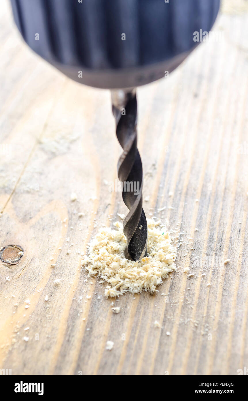 Closeup of drilling a hole in a wooden plank Stock Photo - Alamy