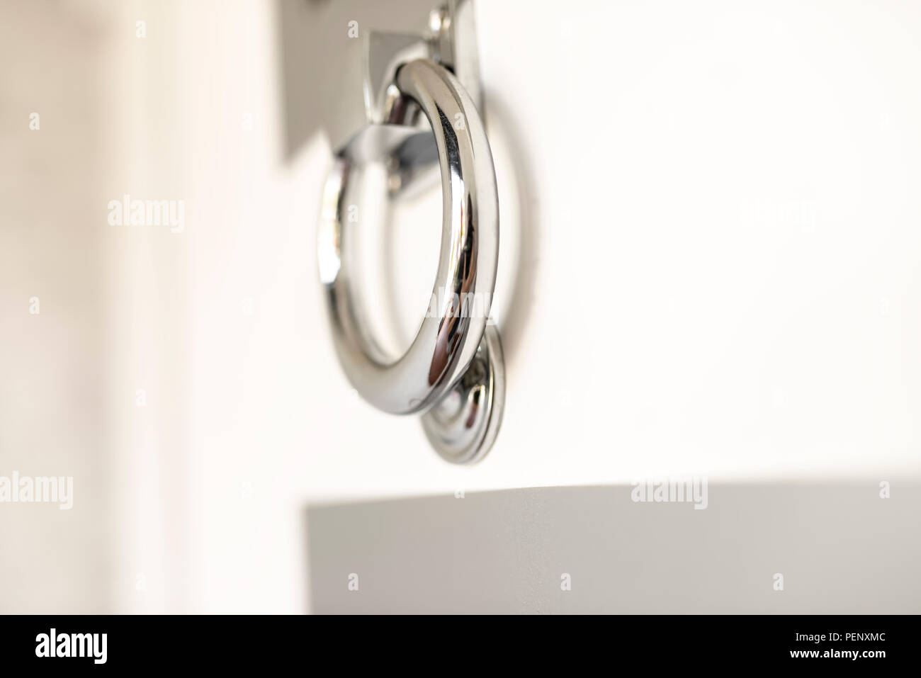 Closeup of modern door knocker Stock Photo - Alamy