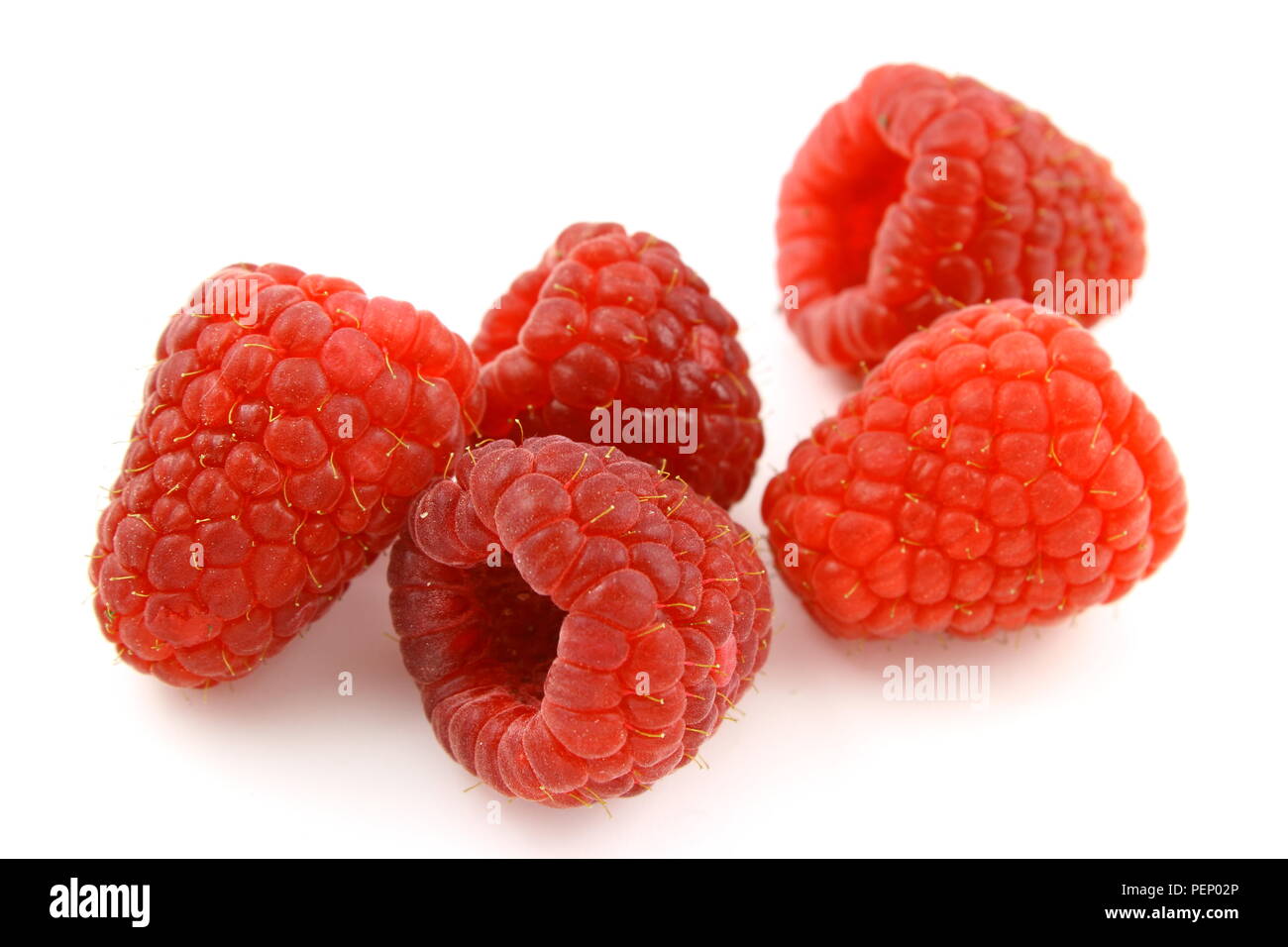 composition of fresh red raspberry fruits isolated on a white ...