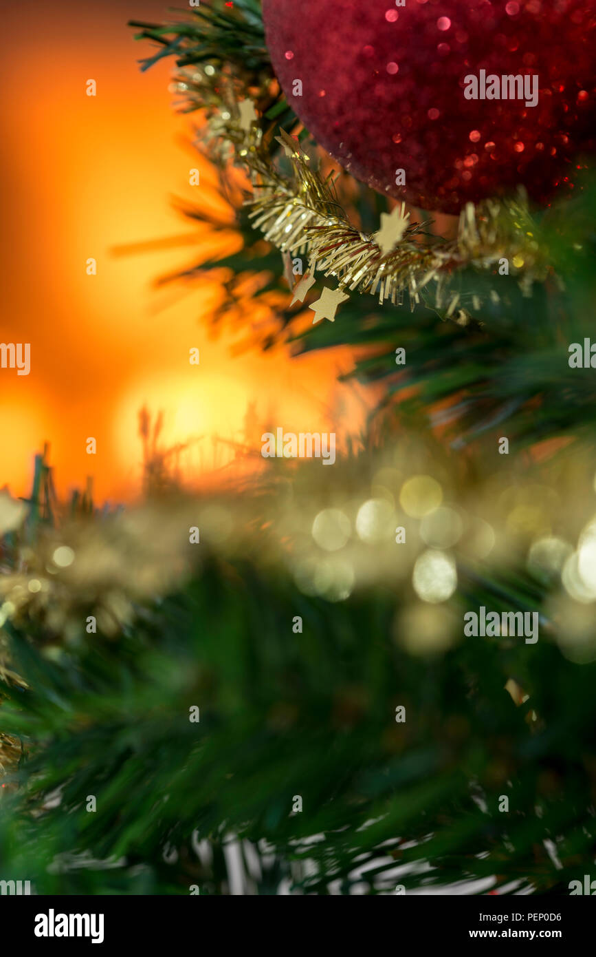 Christmas concept with small golden stars on the branch of a decorated ...