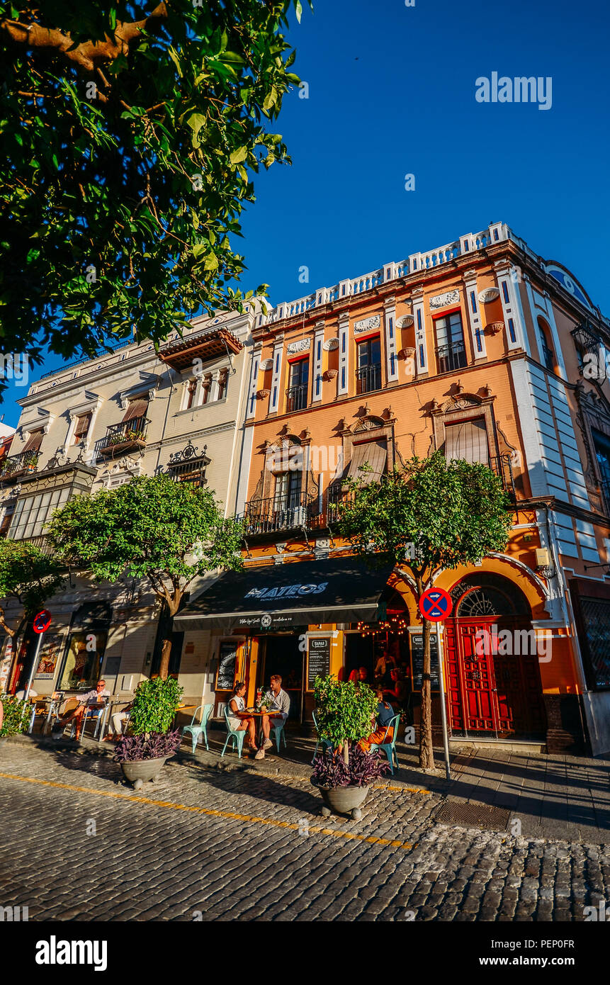 Seville, Spain - July 14th, 2018: Cobblestone street with restaurant ...