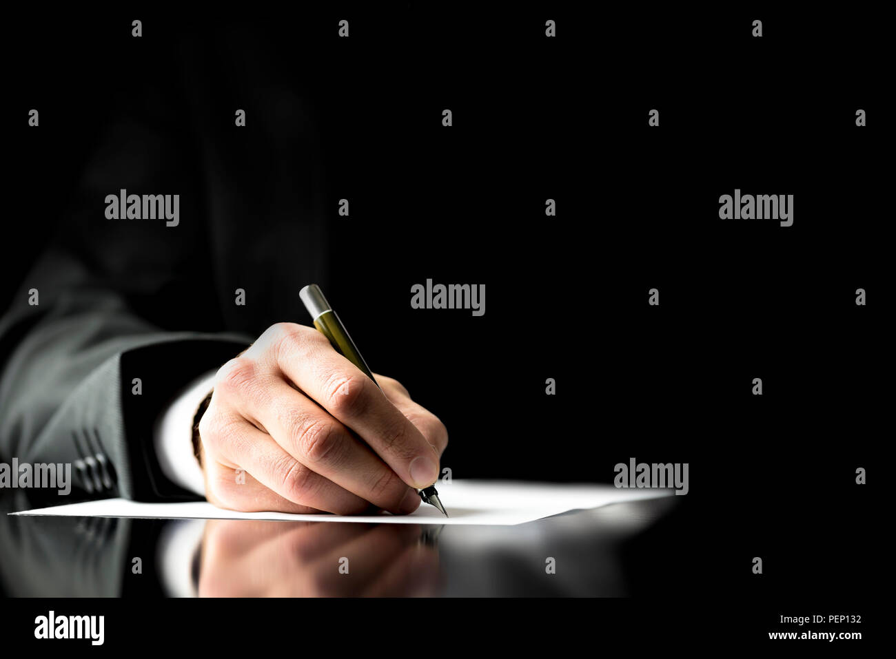 Businessman signing a document, taking notes, completing a ...