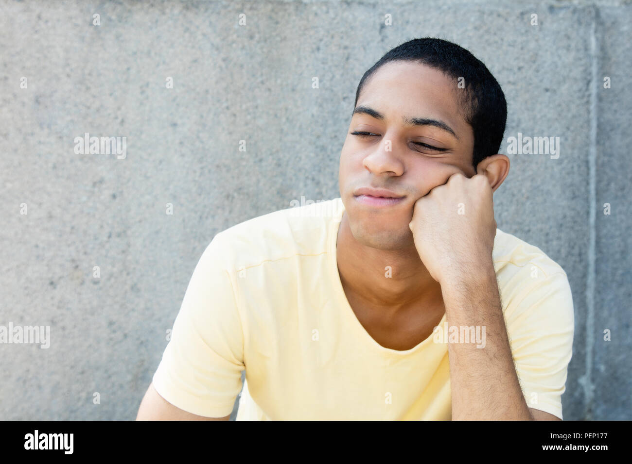 Sad egyptian young adult man outdoors with copy space Stock Photo - Alamy