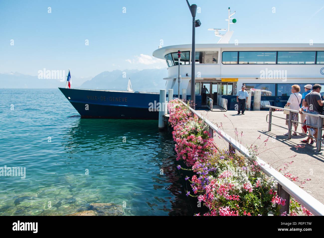 Passengers ready to board modern boat at pier in Lausanne Ouchy port ...