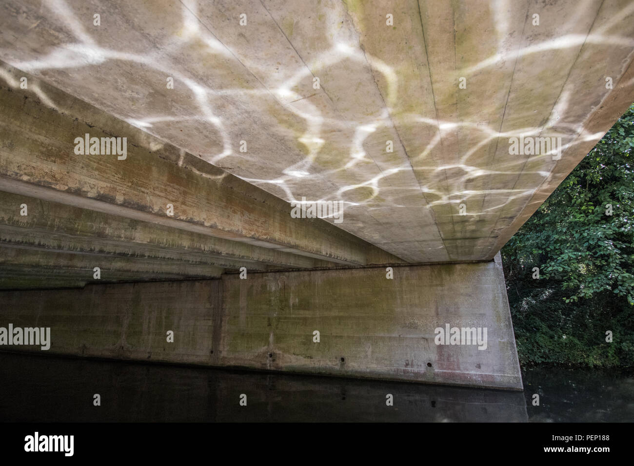 Reflections under the A27 bridge at Chichester Canal, Chichester, West ...