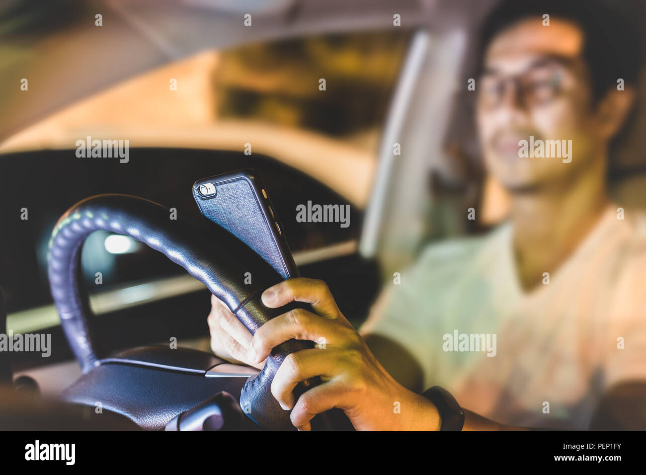 Dangerous concept man using cell phone while driving at night Stock ...
