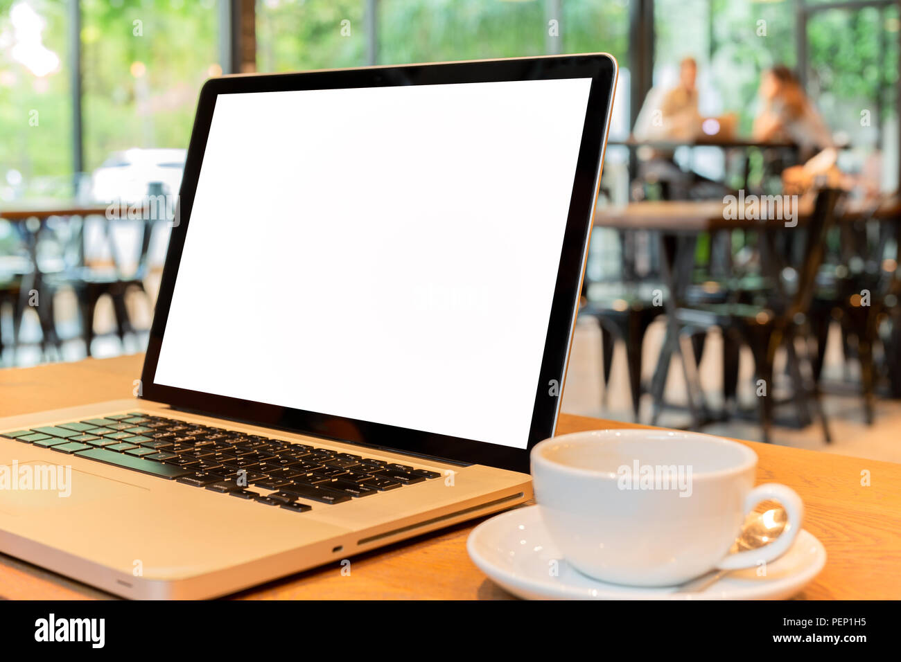 Business object laptop and cp of coffee on a wooden table in cafe Stock ...