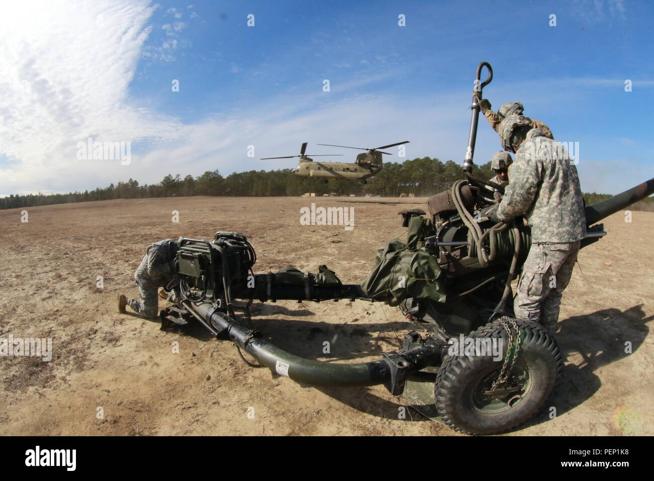 Soldiers from the 82nd Airborne Division Artillery prepare to sling load an M119A3 light ...
