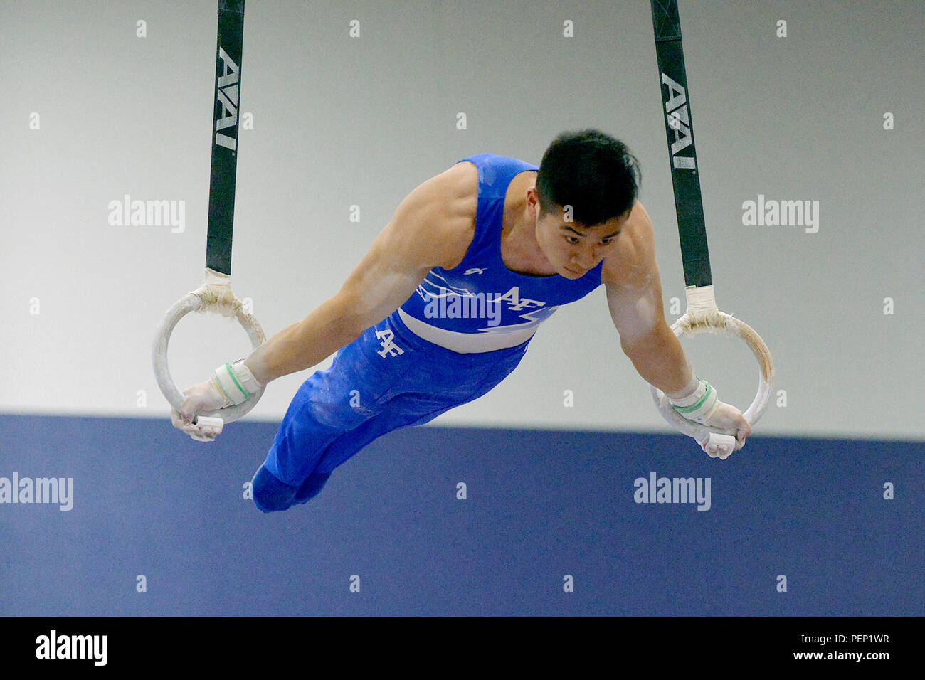 Tim Wang, a junior, performs on the still rings during the Rocky ...