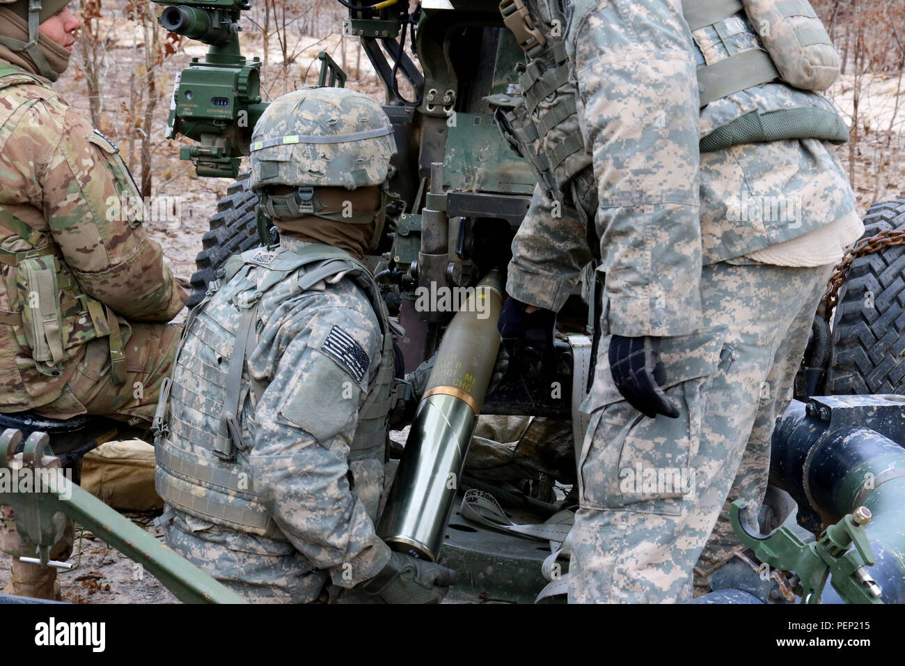 A gunner assigned to the 82nd Airborne Division Artillery loads a 105mm round into a M119A3 ...