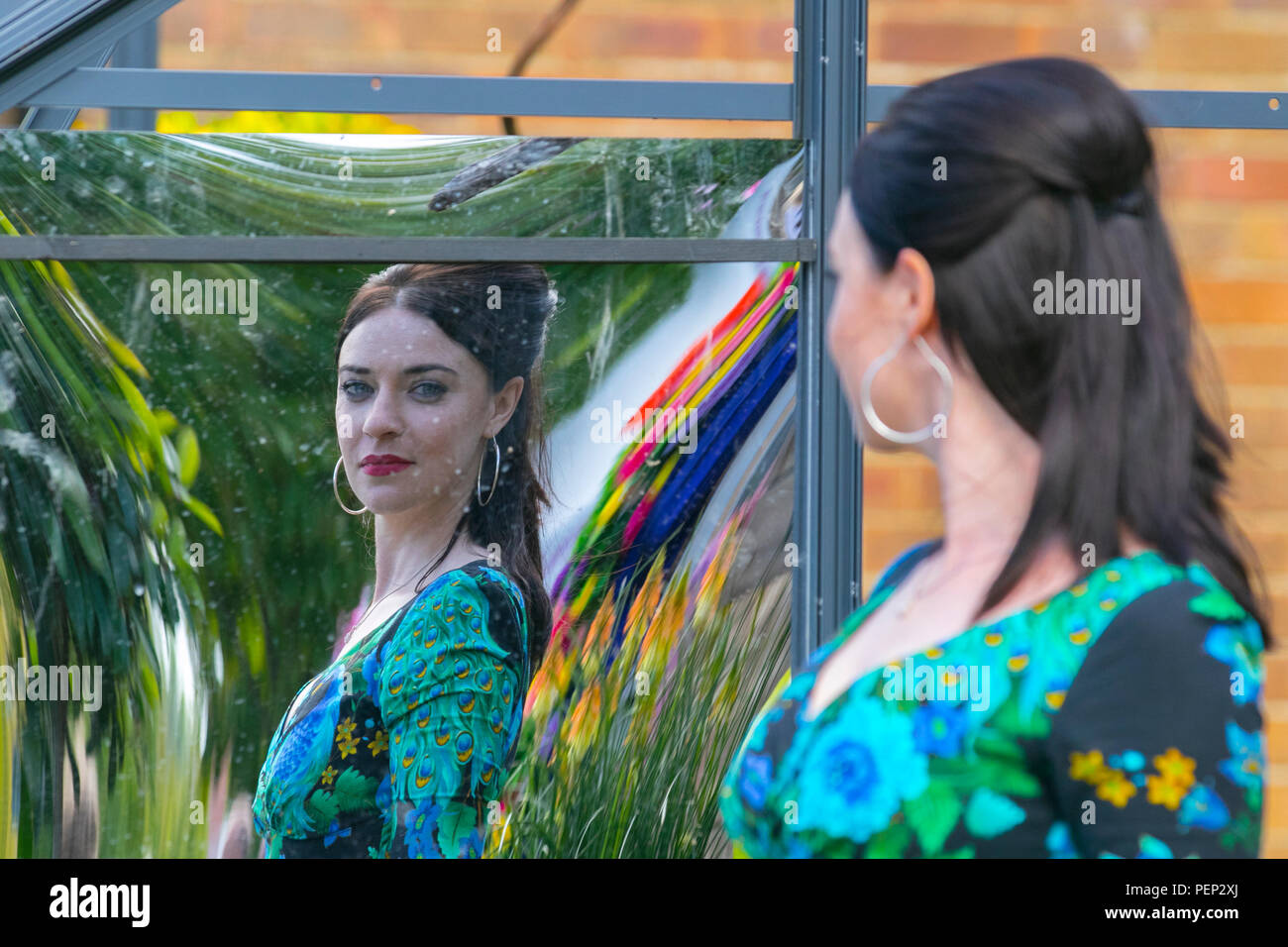 Distorted female images in funhouse curved Mirror in Southport ...