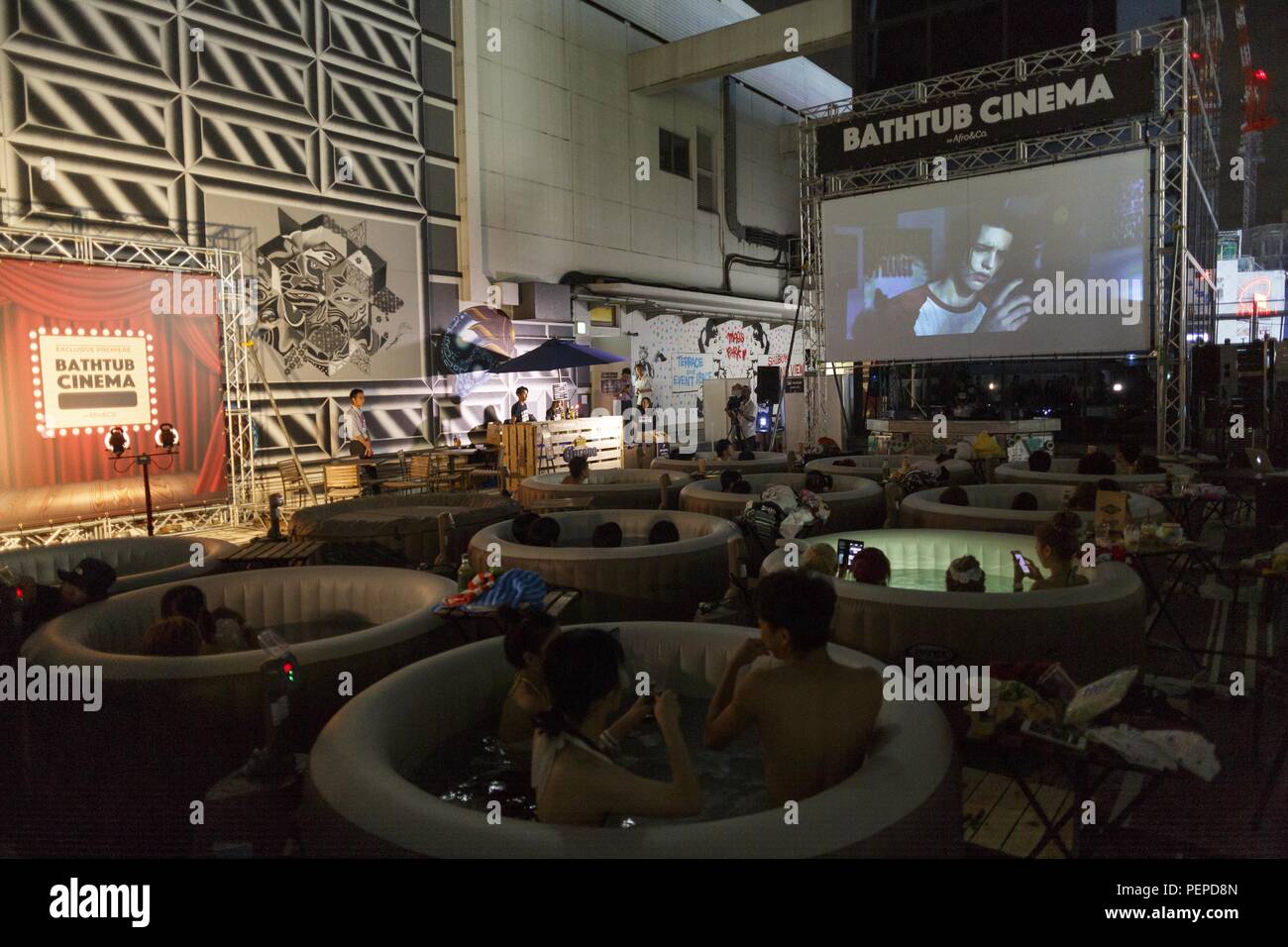Tokyo, Japan. 17th Aug, 2018. People enjoy a movie sitting in small ...