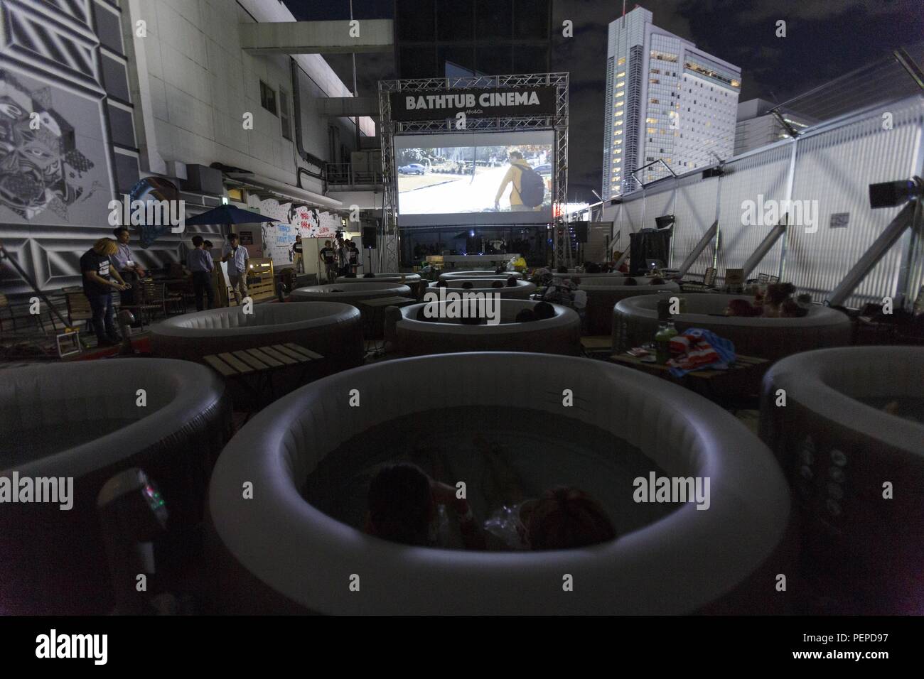 Tokyo, Japan. 17th Aug, 2018. People enjoy a movie sitting in small ...