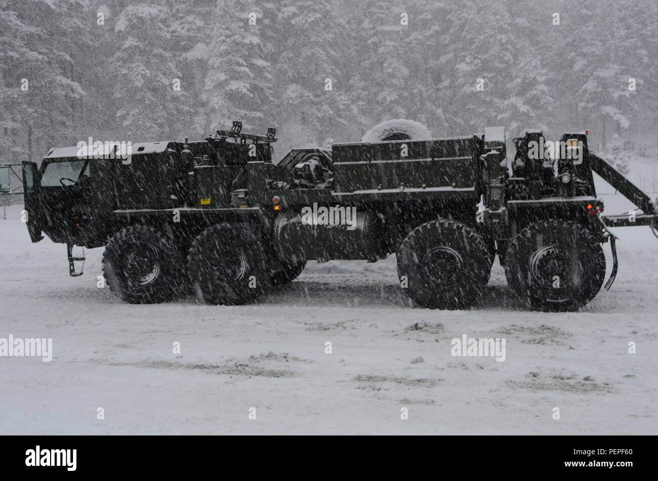 As the snow continues to fall heavily, a U.S. Soldier of 3rd Squadron ...