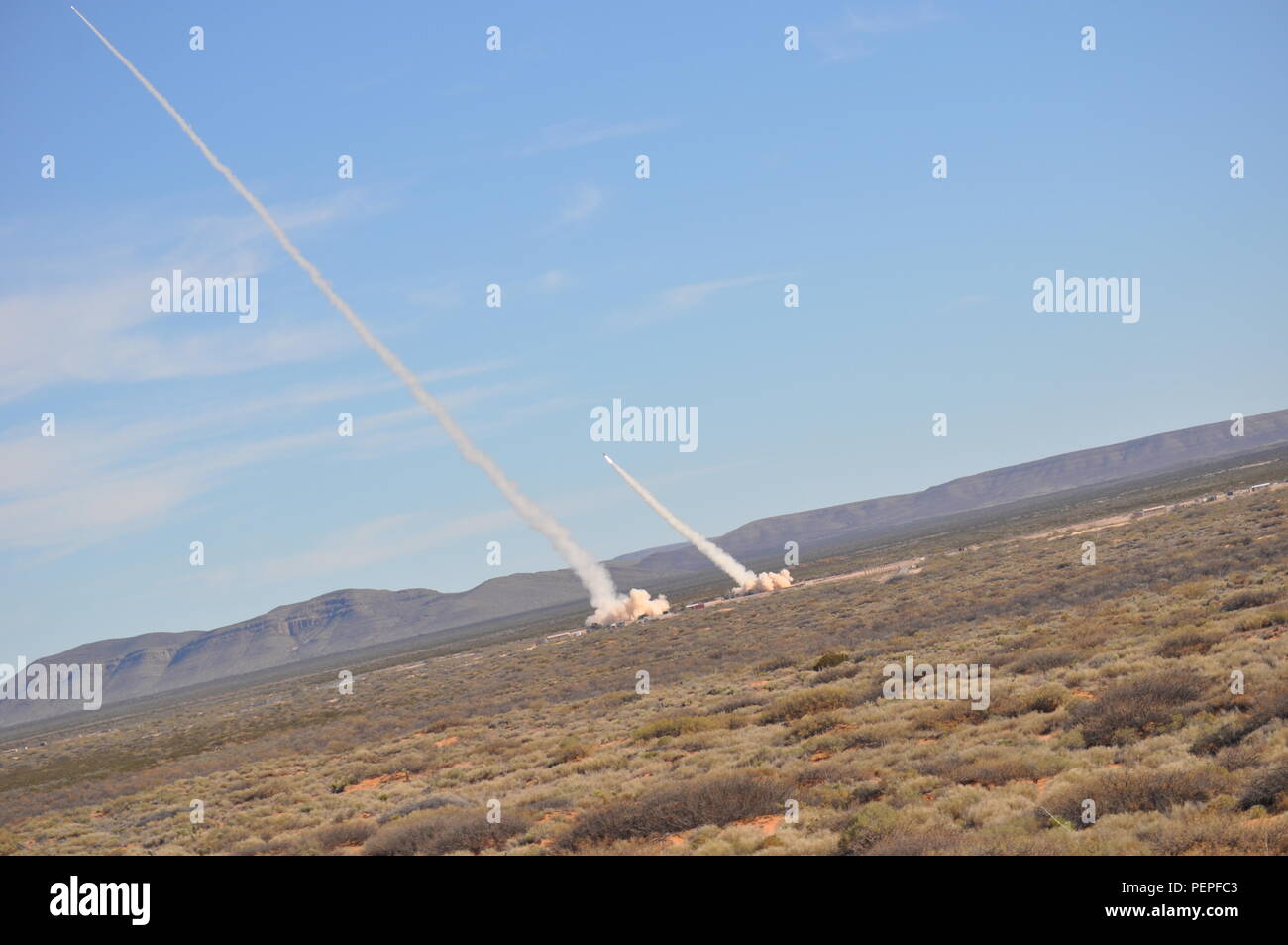 Two HAWK missiles launch into the air, aimed at aerial targets during a ...