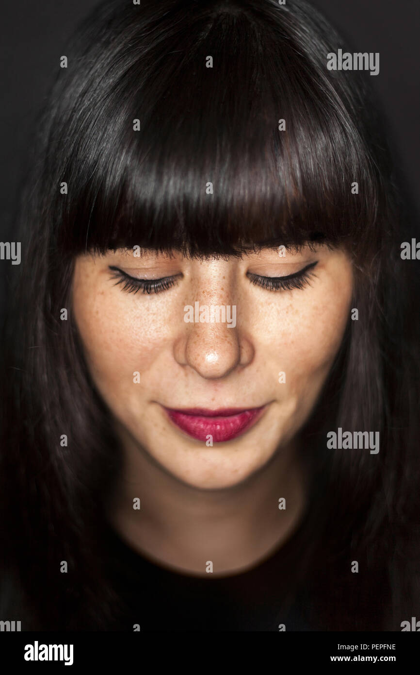 Portrait of a woman looking down Stock Photo - Alamy