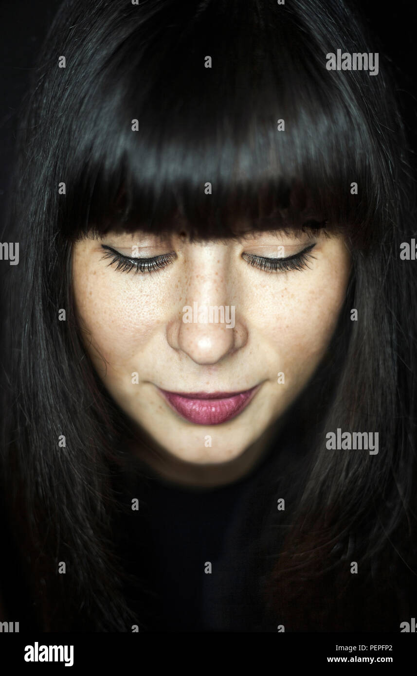 Portrait of a woman looking down Stock Photo - Alamy