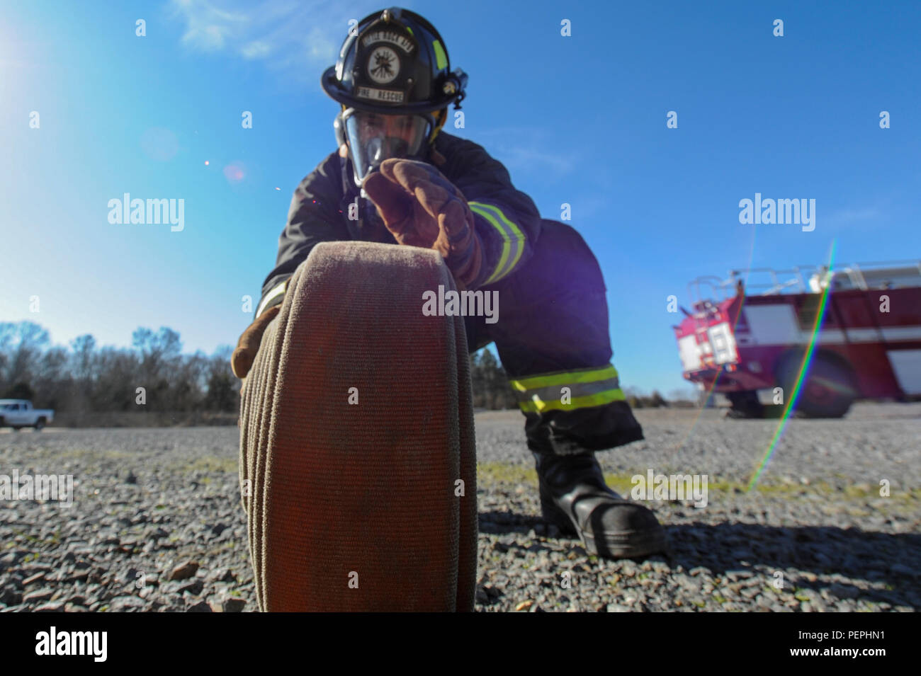 A 19th Civil Engineer Squadron firefighter, rolls hose during an ...