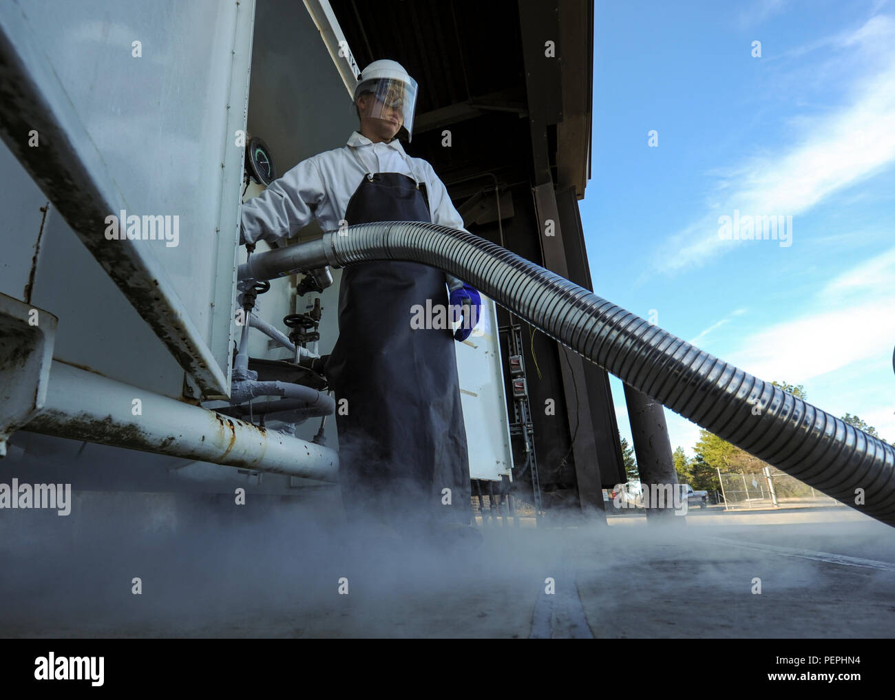 Airman 1st Class Josue Ruiz Garcia, a fuels cryogenic technician fills ...