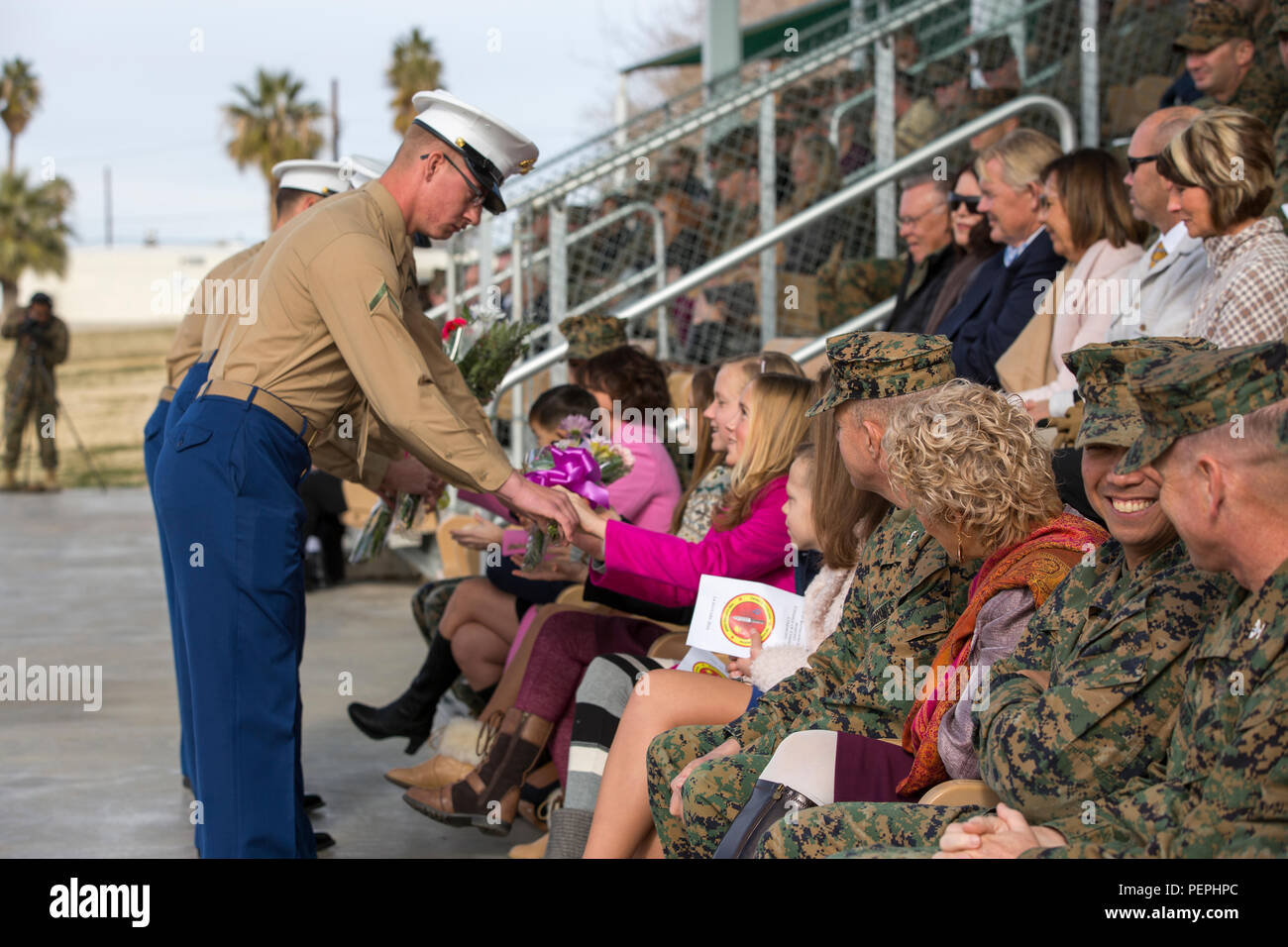 Marines with 3rd Battalion, 7th Marine Regiment, present flowers to the ...