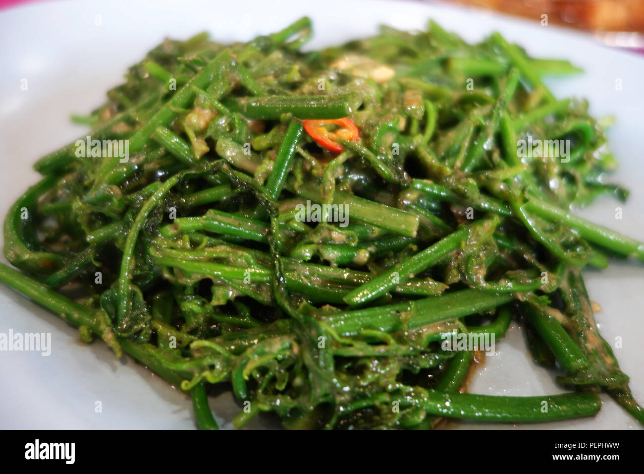 Home cooked stir fried vegetable fern spikes Stock Photo - Alamy