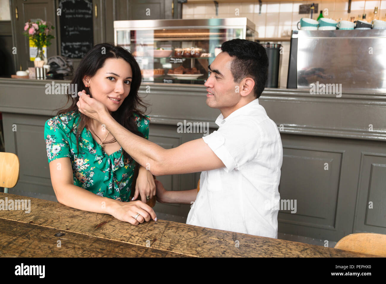 Young man touches hair of his brunette wife Stock Photo - Alamy
