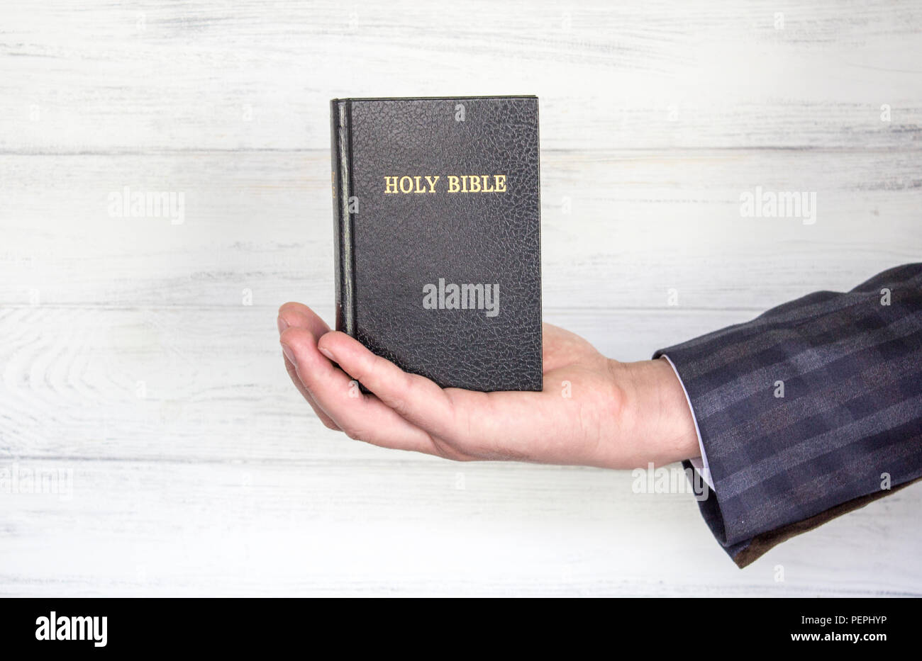 Bible in hand. Holy Letter in the Hands of the Preacher Stock Photo - Alamy