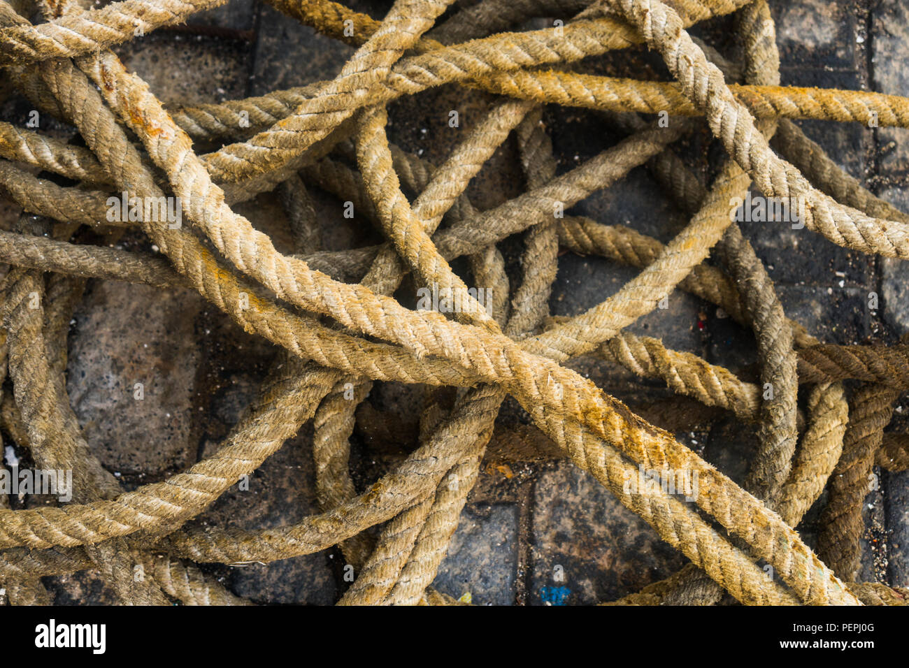 Nautical rope tangled on stone ground from above Stock Photo - Alamy