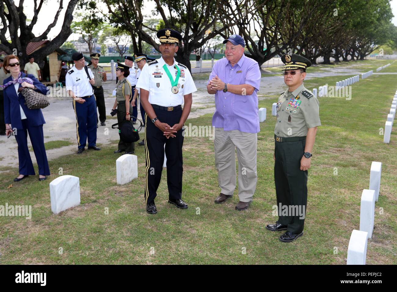 Larry Adkison, of the American Battle Monuments Commission (center ...
