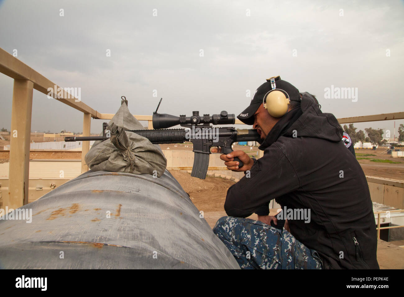 An Iraqi policeman aims an M16 rifle during advanced marksmanship ...