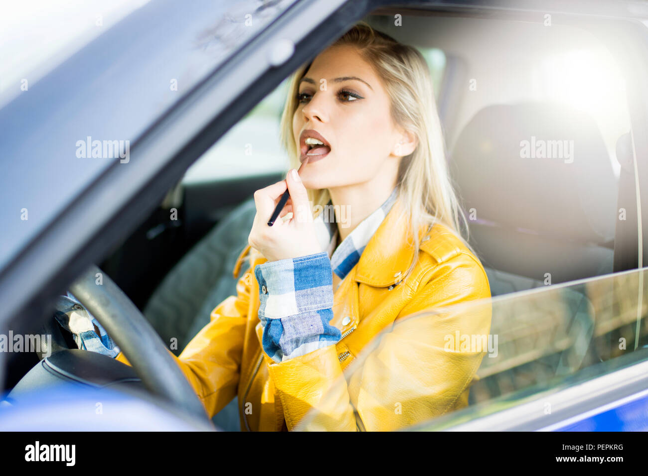 beautiful woman doing makeup in the car Stock Photo - Alamy