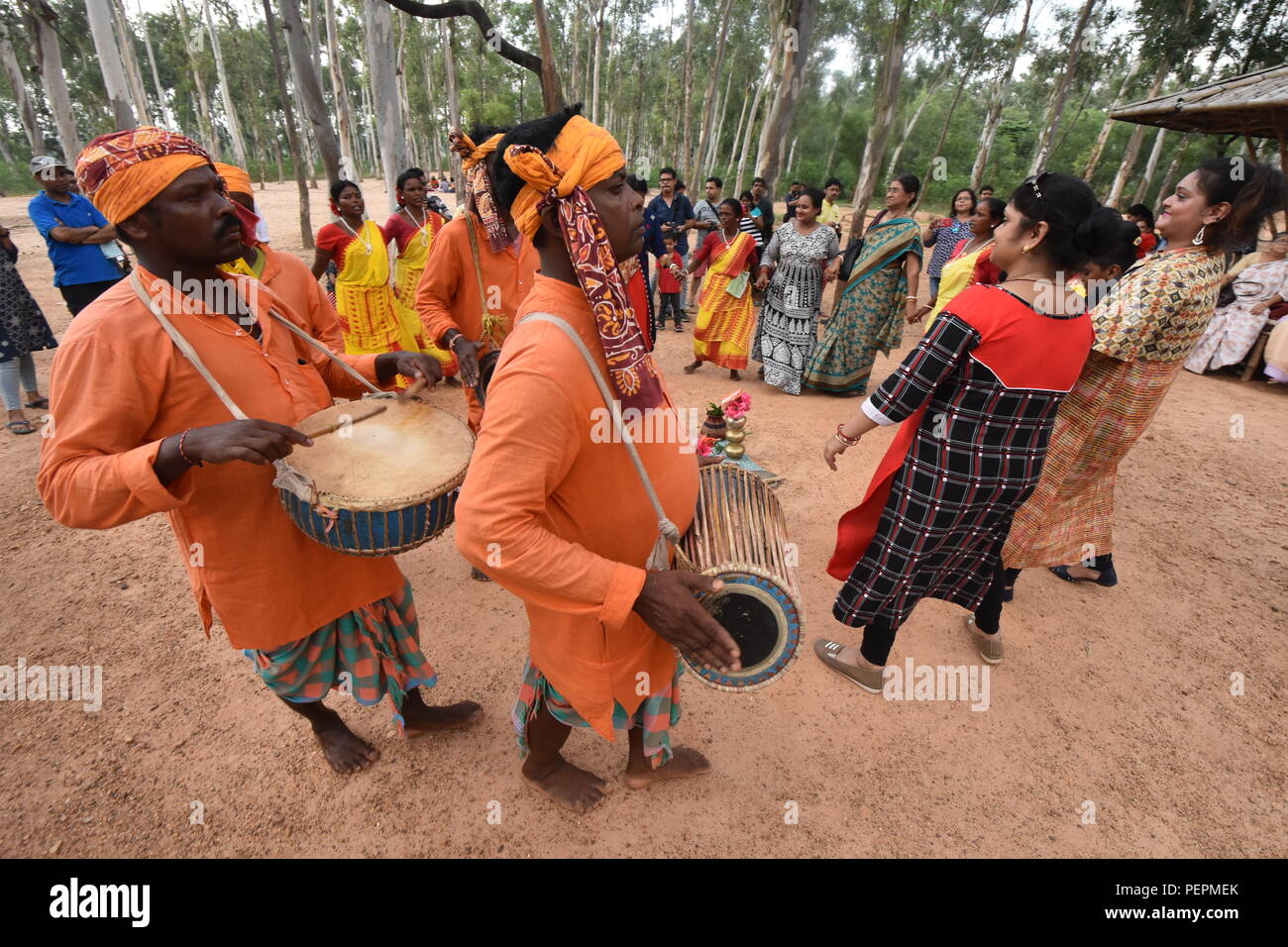Tourists are dancing and singing with local traditional dressed Santali ...