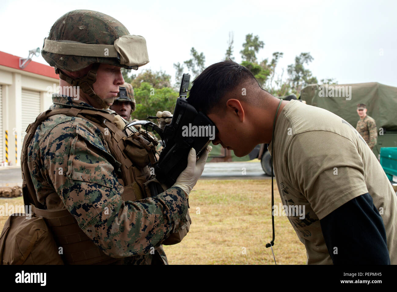 A Marine uses a Biometric Enrollment Screening Device to take an iris ...