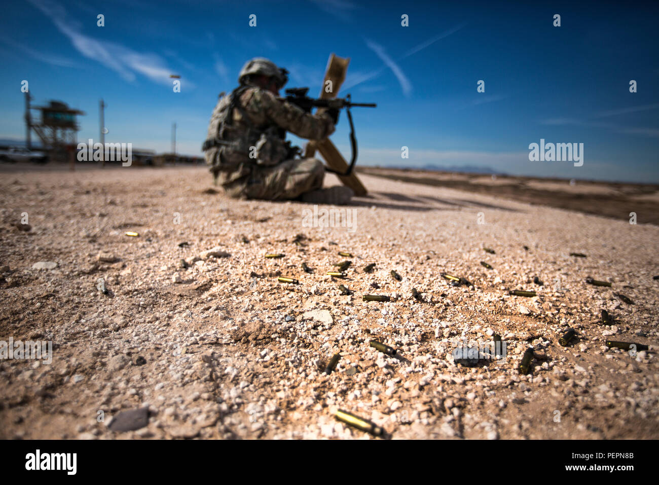 Bullet casings surround a Desert Warrior student during an M4 rifle ...