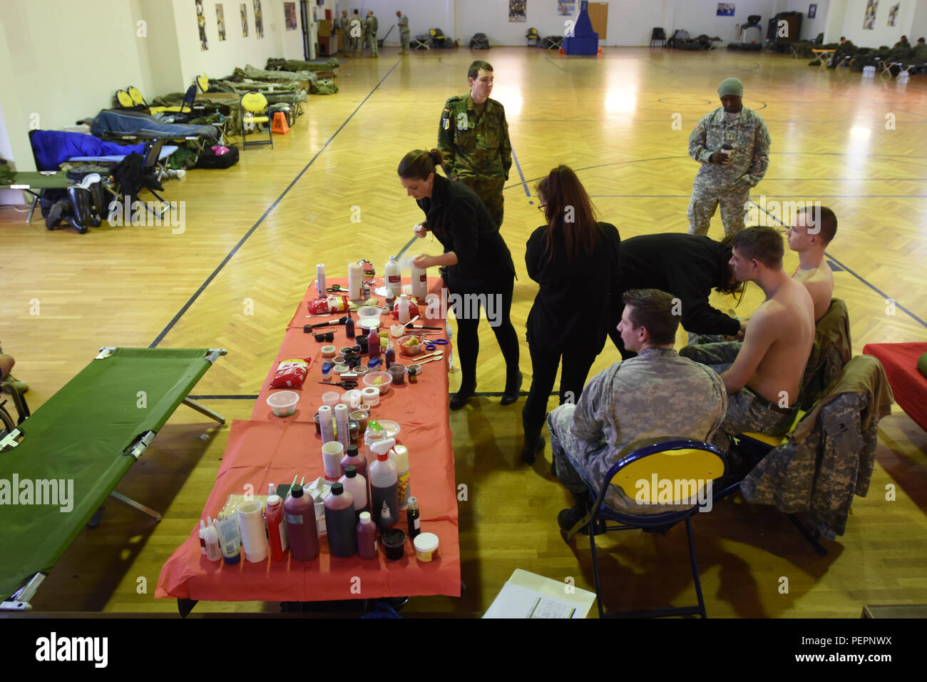 The moulage team prepares role players for patient play during 30th ...